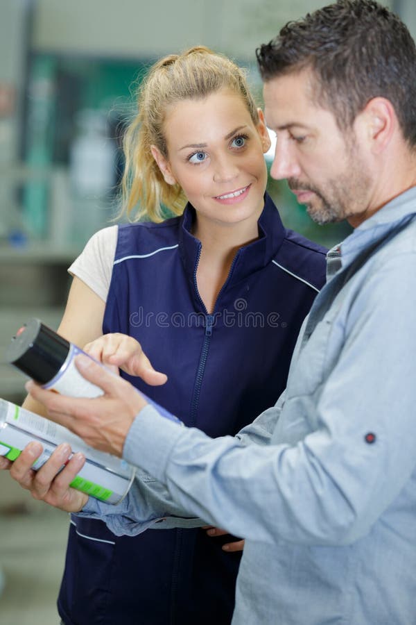 Female Shop Assistant Helping Male Customer Stock Image - Image of ...