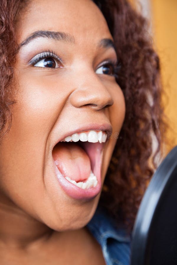 Female Singer with Mouth Open Performing in Recording Studio Stock ...