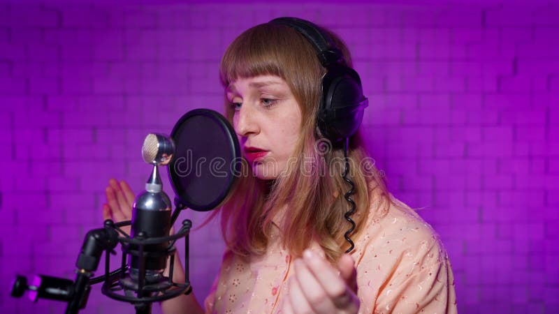 Female Singer in Recording Studio Performs Song into Microphone with ...