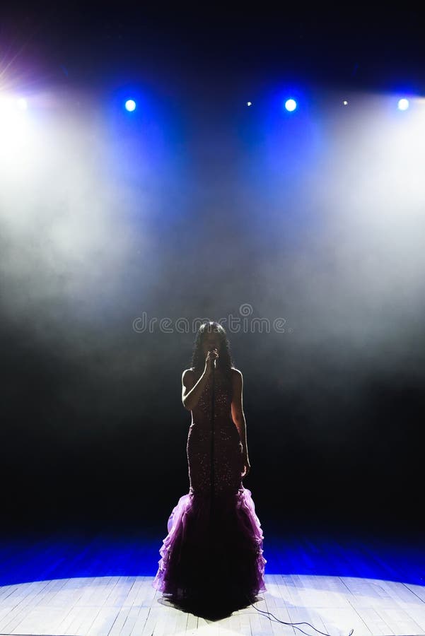 Female Singer on the Stage Holding a Microphone. Stock Image - Image of ...