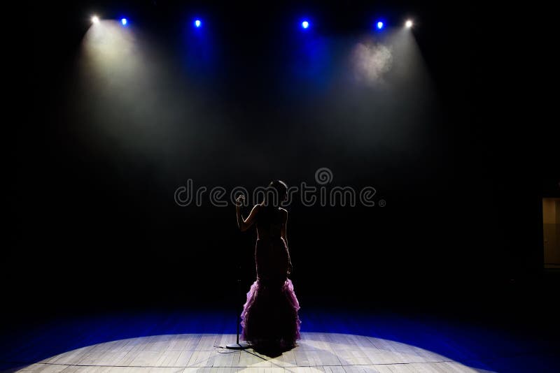 Female Singer on the Stage Holding a Microphone. Stock Image - Image of ...