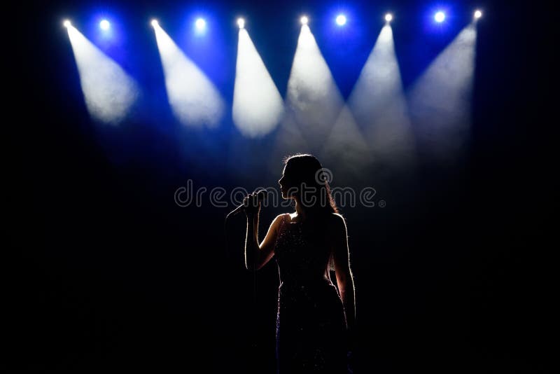 Female Singer on the Stage Holding a Microphone. Stock Photo - Image of ...