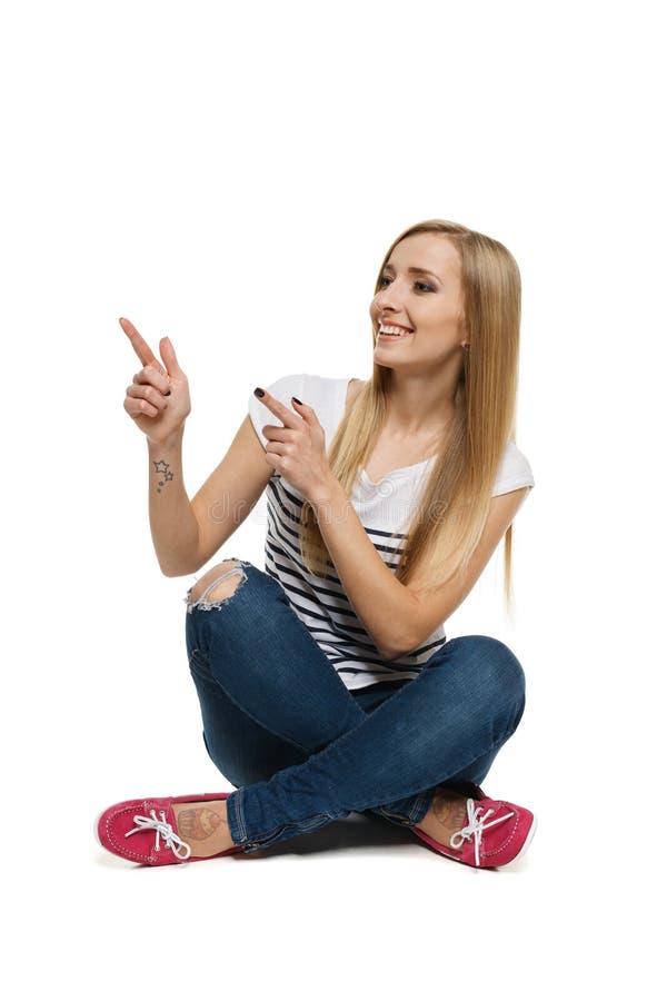 Female Sitting with Crossed Legs on the Floor Pointing To the Side ...