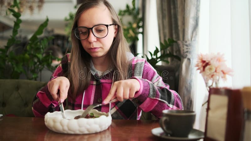 Female Sitting At Table With Plate Of Food A Woman Is Sitting At A