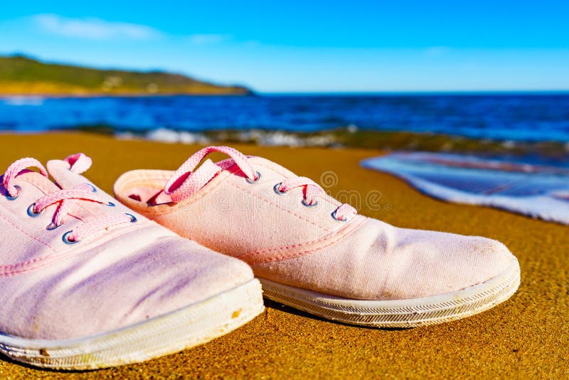 Female Sneakers on Sand Beach Stock Photo - Image of sneakers, waves ...