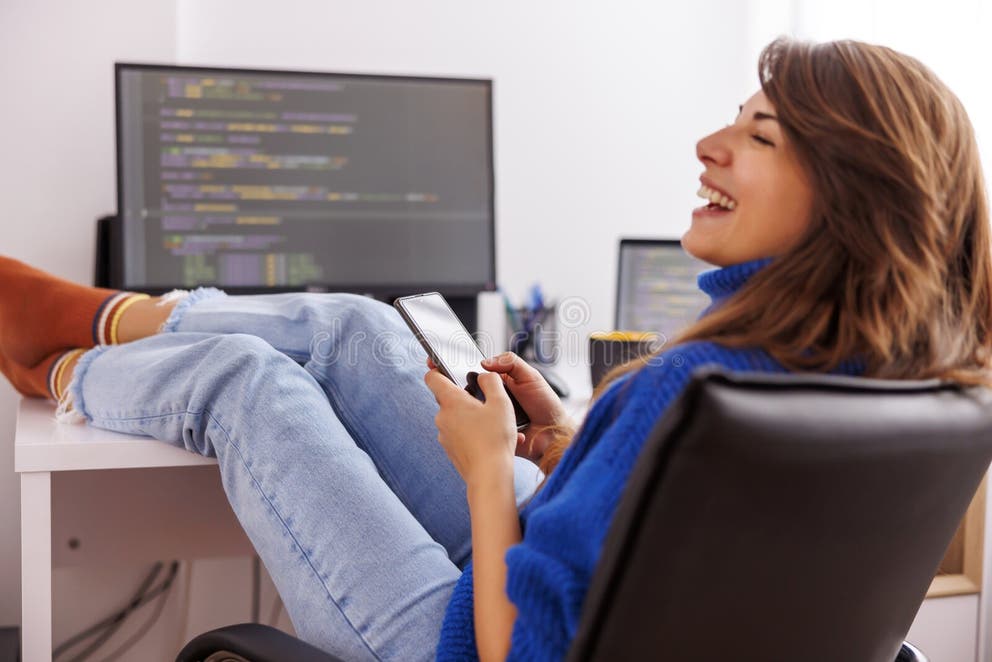 Female Software Developer Using Smart Phone while Taking a Break from ...