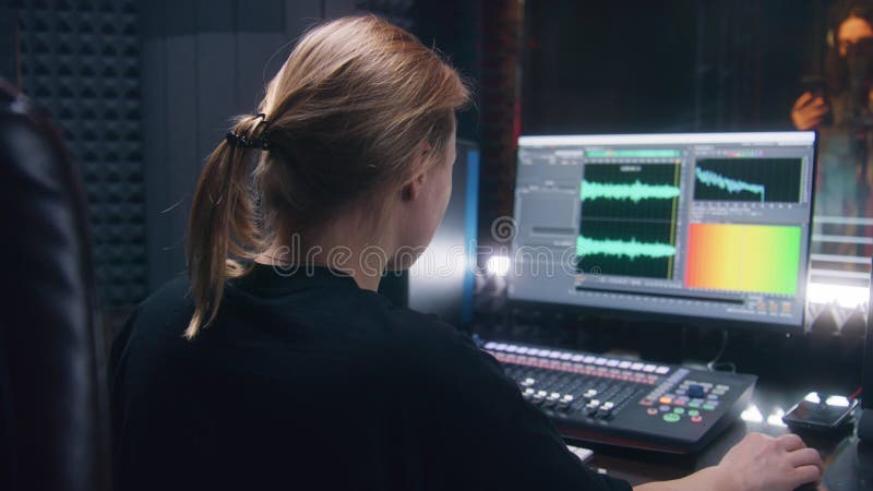 Female Sound Engineer Uses Control Mixing Surface and Computer Stock ...