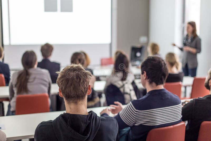 Woman Giving Presentation in Lecture Hall at University. Editorial ...