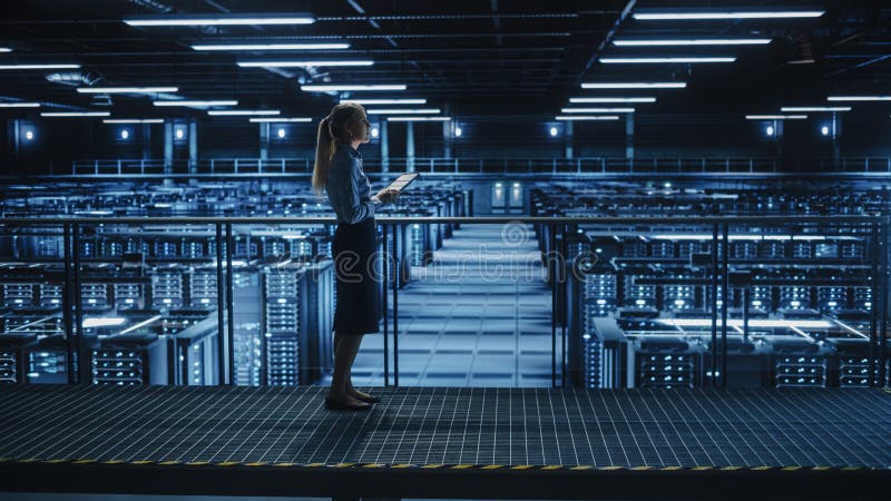 Female it Specialist Using Tablet Computer in Data Center, Walking on a ...