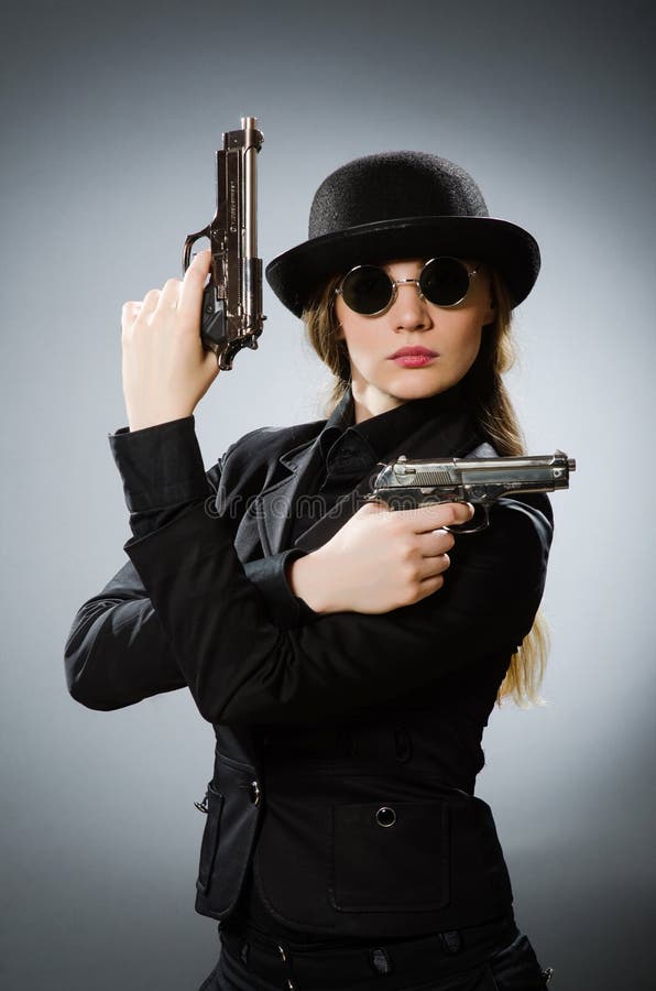 The Female Spy with Weapon Against Gray Stock Image - Image of clothes ...