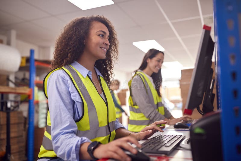 Female Staff in Busy Modern Warehouse Working on Computer Terminals ...
