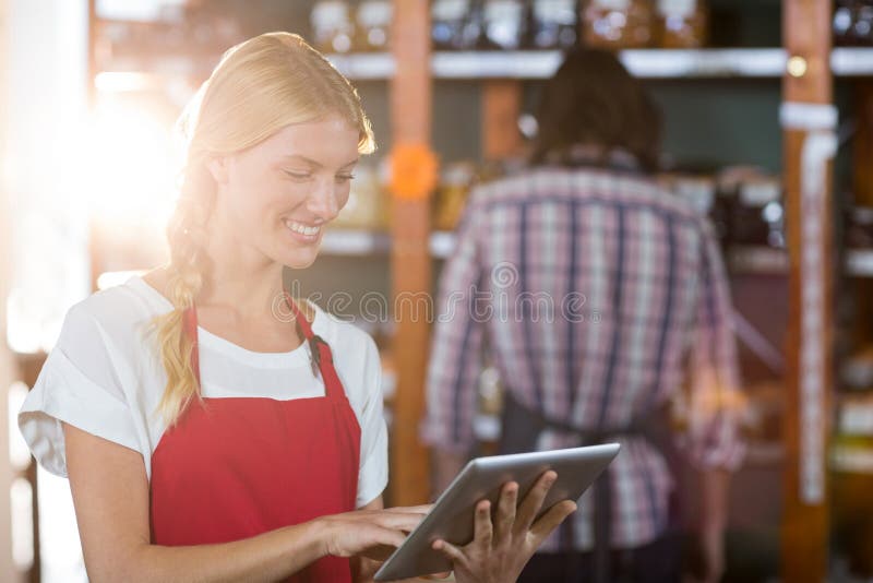 Female Staff Using Digital Tablet in Supermarket Stock Image - Image of ...