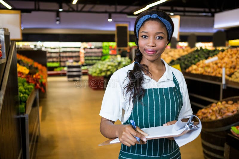 African American Woman Wearing Striped Apron Checking Produce with ...