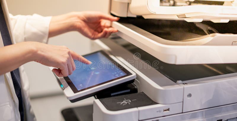 Female Standing and Hand Pressing Button on a Copy Machine in the ...
