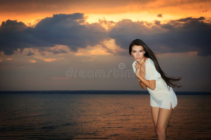 Female Standing Near Ocean in Rays of Sunset Stock Photo - Image of ...