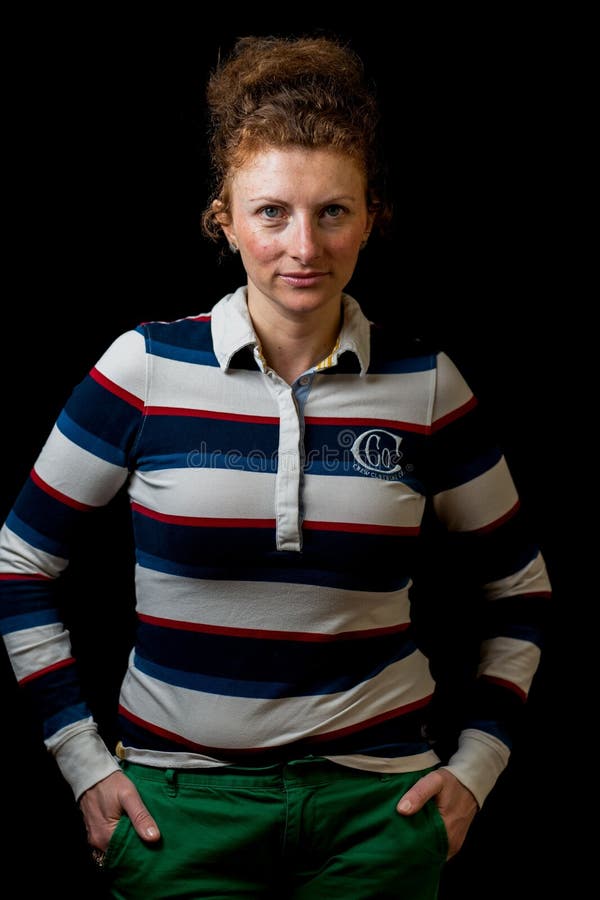 Female Standing in a Shadowy Space Arms Akimbo in a Confident Posture ...