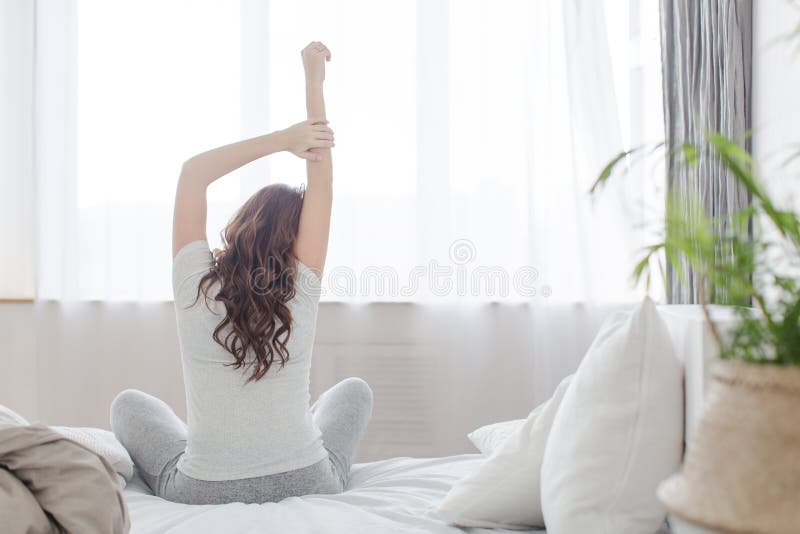 Female Stretching Sitting on Bed in Morning Stock Image - Image of ...