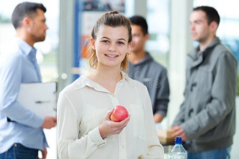 Female student with apple stock photo. Image of education - 269559796