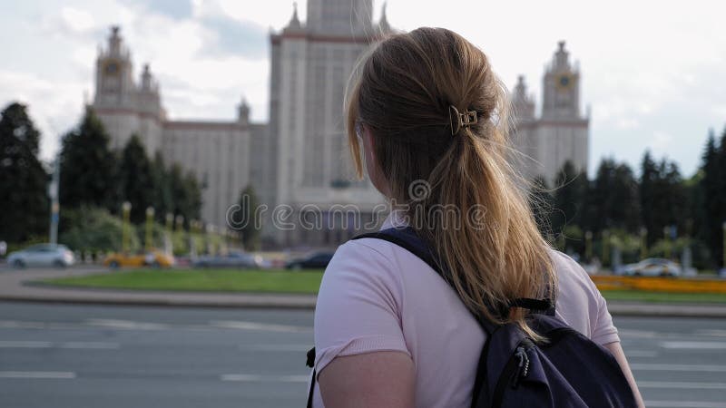 A Female Student with a Backpack Stands and Looks at the State ...