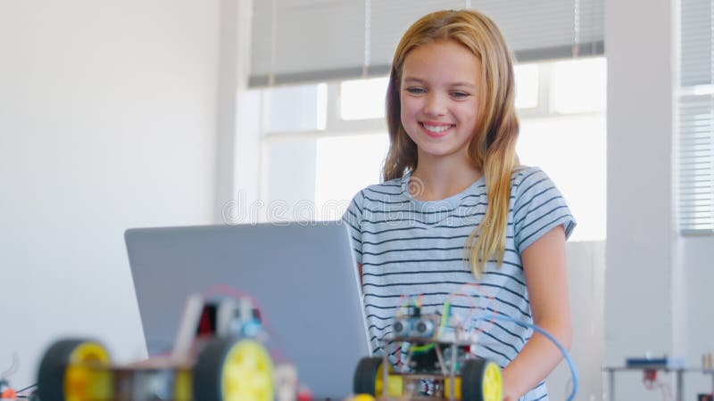Female Student Building and Programming Robot Vehicle in after School Computer Coding Class ...