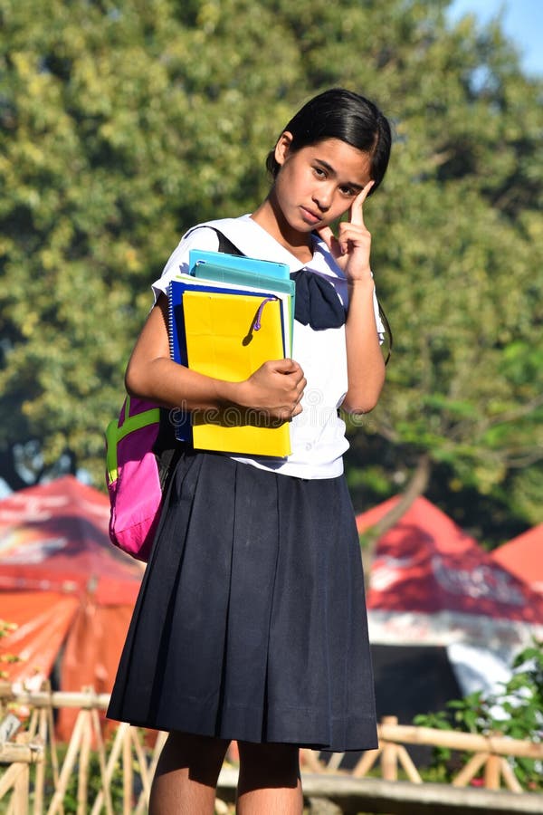 Female Student Decision Making Wearing School Uniform with School Books ...
