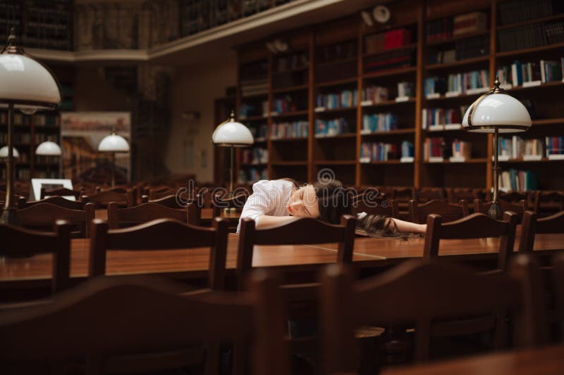 Female Student Fell Asleep Reading a Book in a Public Library, Lying on ...
