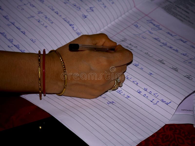 Student Hand Writing Maths Problem on White Paper Book for Education ...
