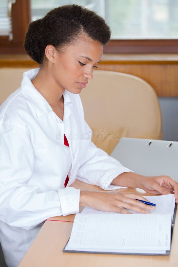 Female Student in Labcoat Sat Working at Desk Stock Image - Image of ...