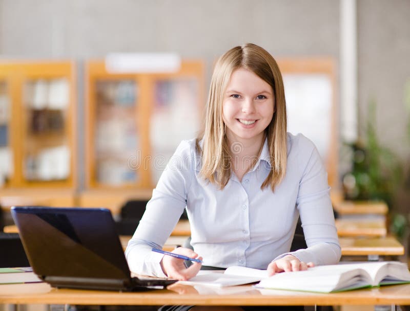 Working in the Library stock image. Image of cheeky, smile - 112583