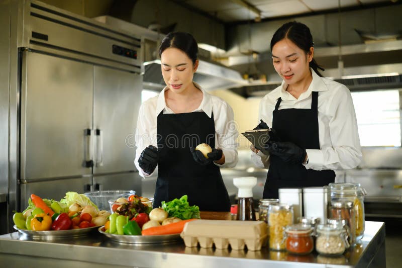 Female Student Learning Food Preparation Techniques in Cooking Class ...