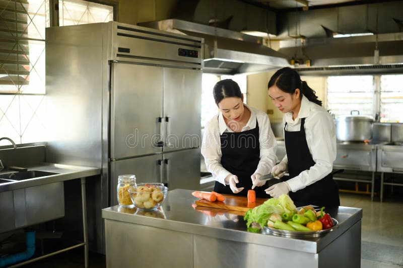 Female Student Learning To Cut Vegetables during a Hands on Culinary ...