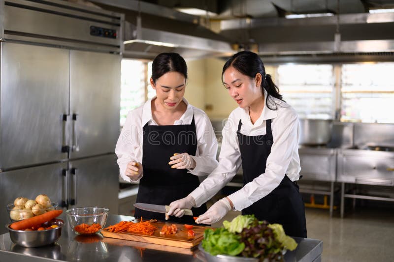 Female Student Learning To Cut Vegetables during a Hands on Culinary ...