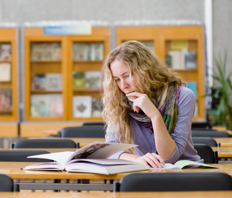 Female Student Reads the Book in Library Stock Photo - Image of ...