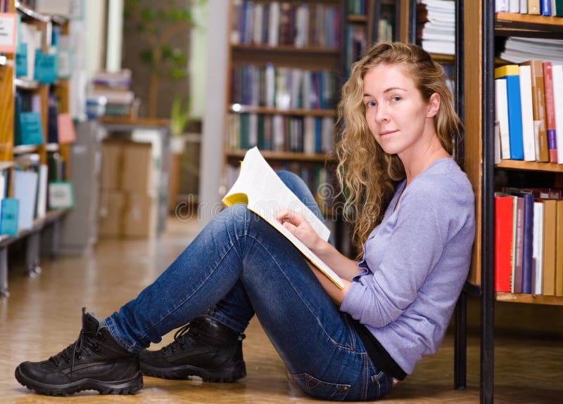 Female Student Reads the Book in Library Stock Photo - Image of ...