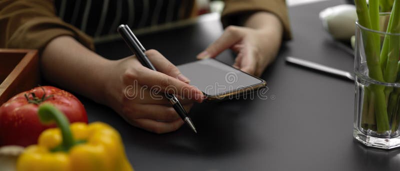 Female Student Looking Informations on Mock-up Smartphone in Cooking ...
