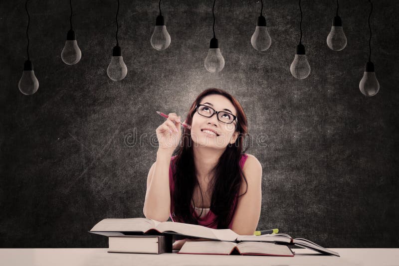 Female Student Looking at Light Bulbs Stock Image - Image of board ...