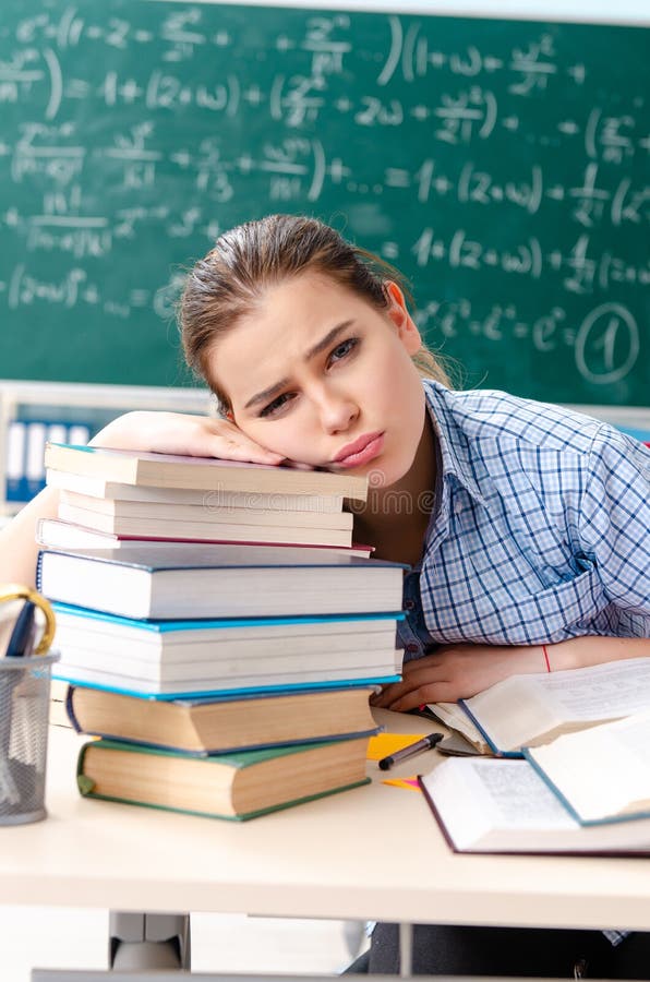 The Female Student with Many Books Sitting in the Classroom Stock Image ...