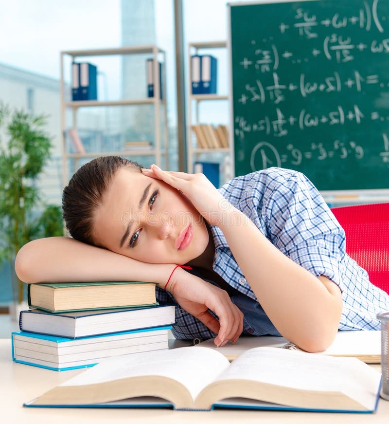 Female Student with Many Books Sitting in the Classroom Stock Photo ...