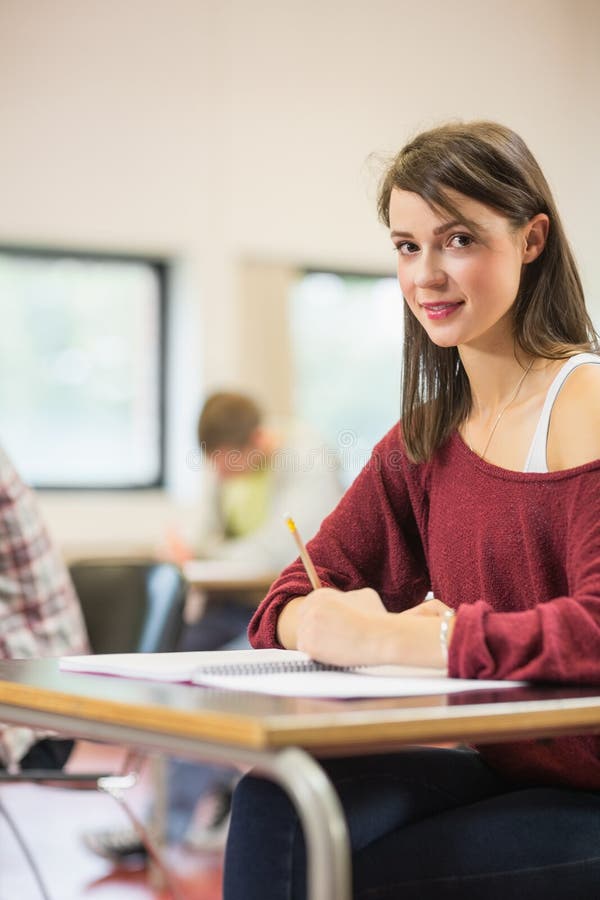Female Student with Others Writing Notes in the Classroom Stock Photo ...