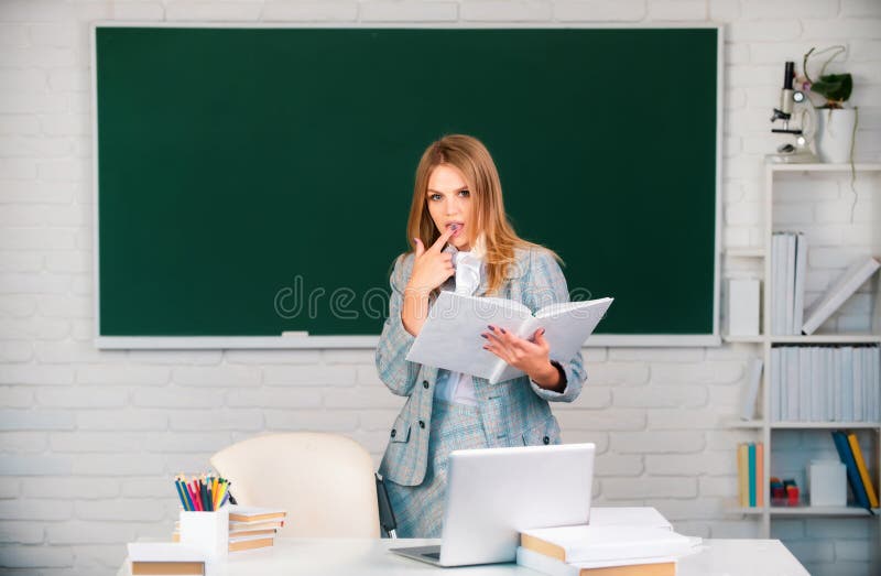 Female Student Reading Book on Lesson Lecture in Classroom at High ...