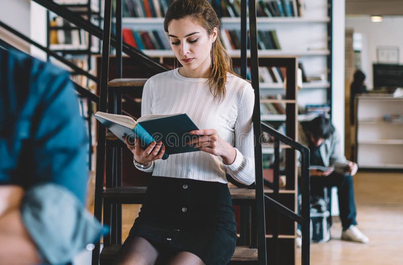 Female Student Reading Book in Library Stock Image - Image of erudite ...
