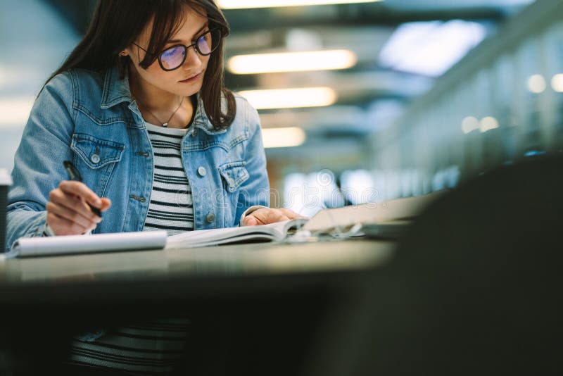 Female Student Reading a Book and Writing Notes Stock Image - Image of ...