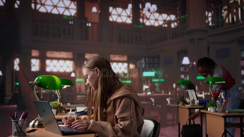 Female Student Reading and Writing Detailed Notes for an Exam Stock ...