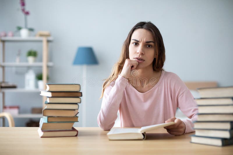 Female Student Sits at a Table with Books Preparing for Exams Stock ...