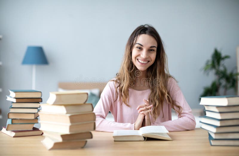 Female Student Sits at a Table with Books Preparing for Exams Stock ...