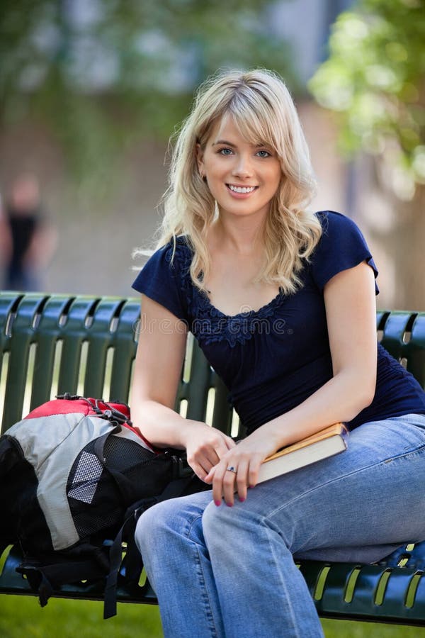Female College Student Sitting On Bench With Book Stock Image - Image ...