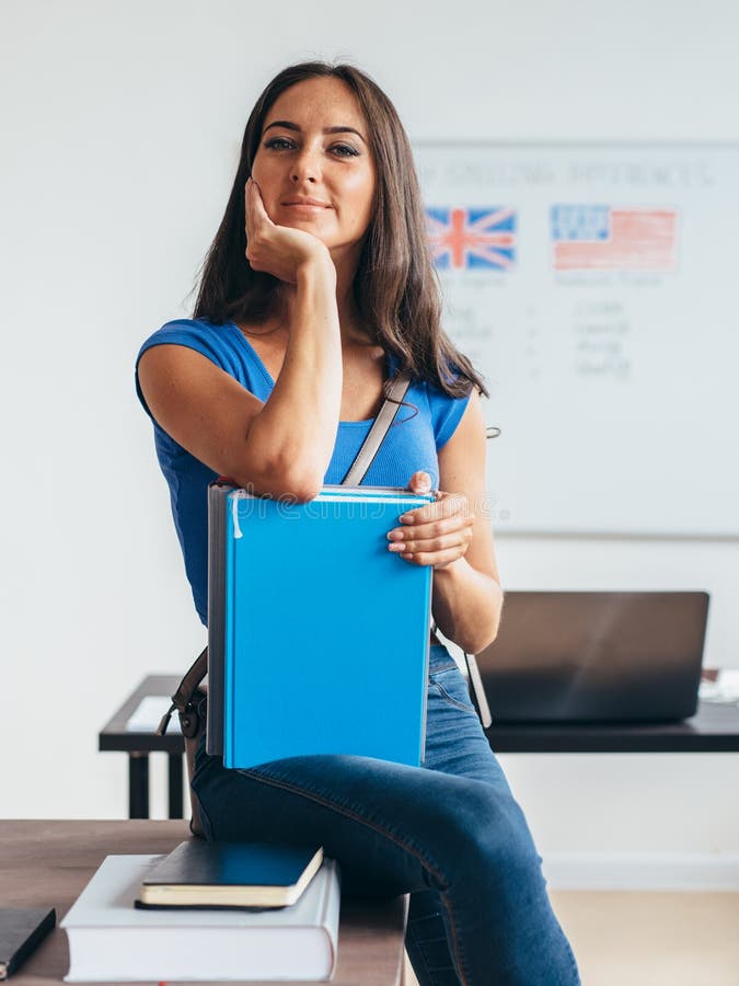 Female Student Sitting at Table Smiling and Looking at Camera. Stock ...