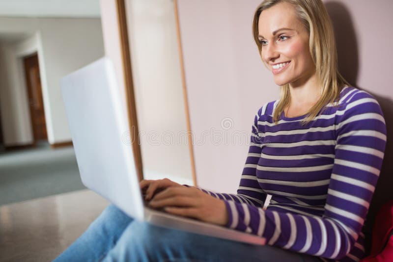 Female Student Smiling while Using Laptop Stock Photo - Image of casual ...