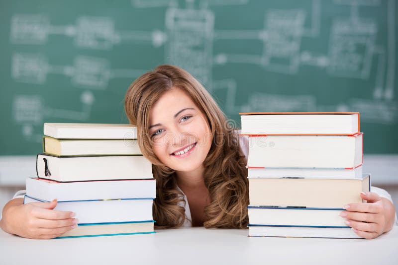 Female Student with Stack of Books at Table Stock Image - Image of ...
