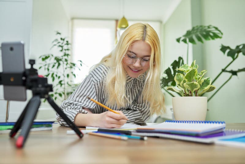 Female Student Teenager Studying at Home Online Using Smartphone. Stock ...